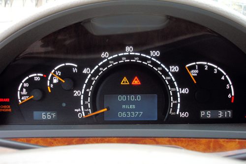 Why is my car's brake warning light on, and is it safe to continue driving?